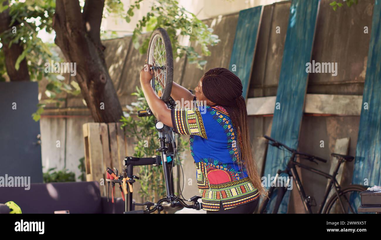 Active african american woman cautiously loosening and removing damaged ...