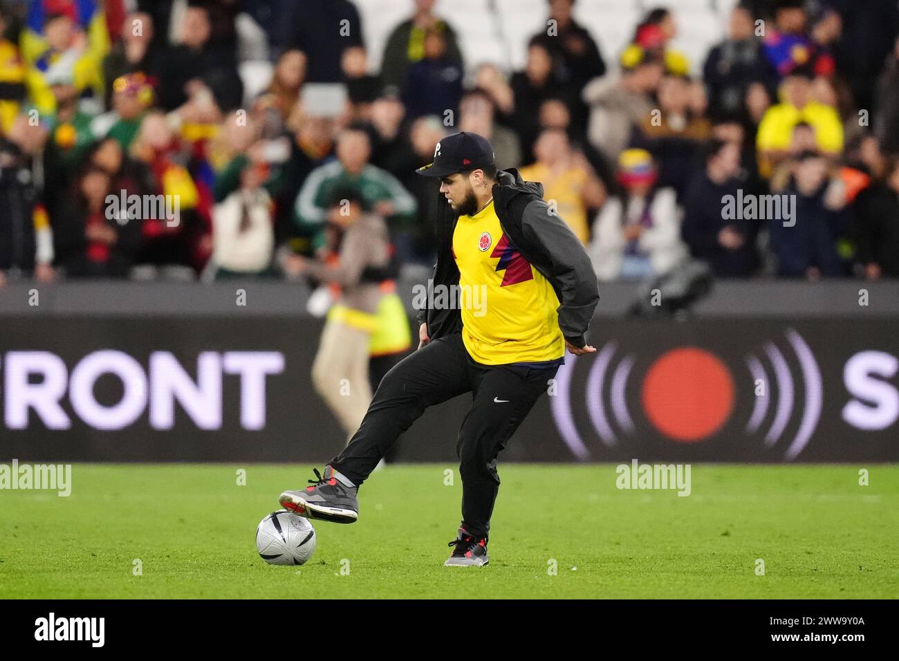 A pitch invader plays football on the pitch following an international ...