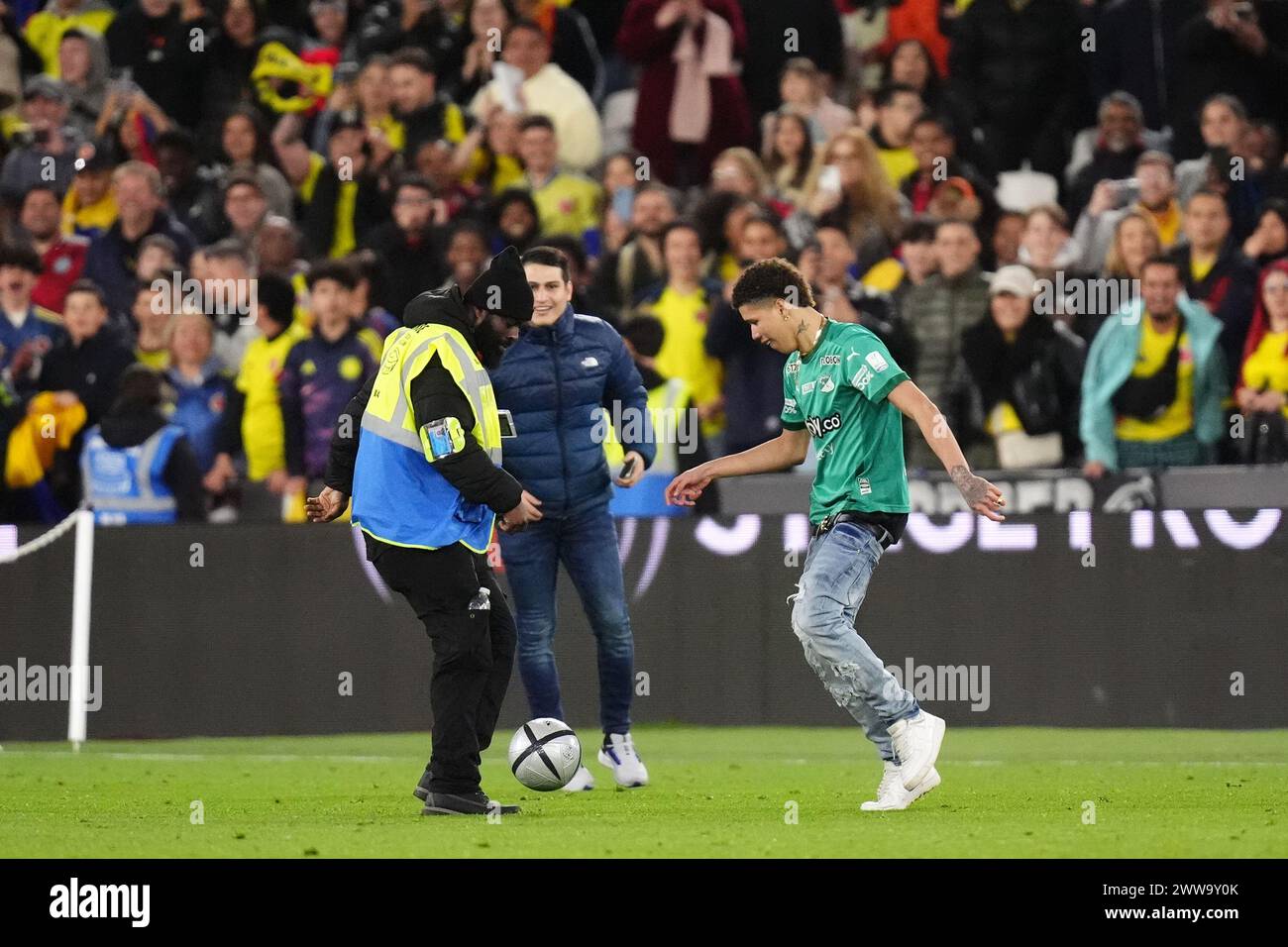 A pitch invader plays football on the pitch following an international ...