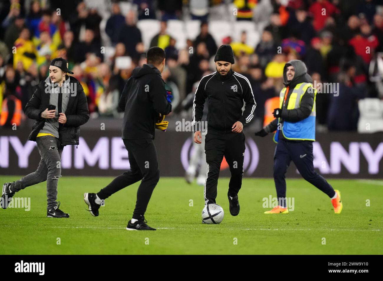Pitch invaders play football on the pitch following an international ...