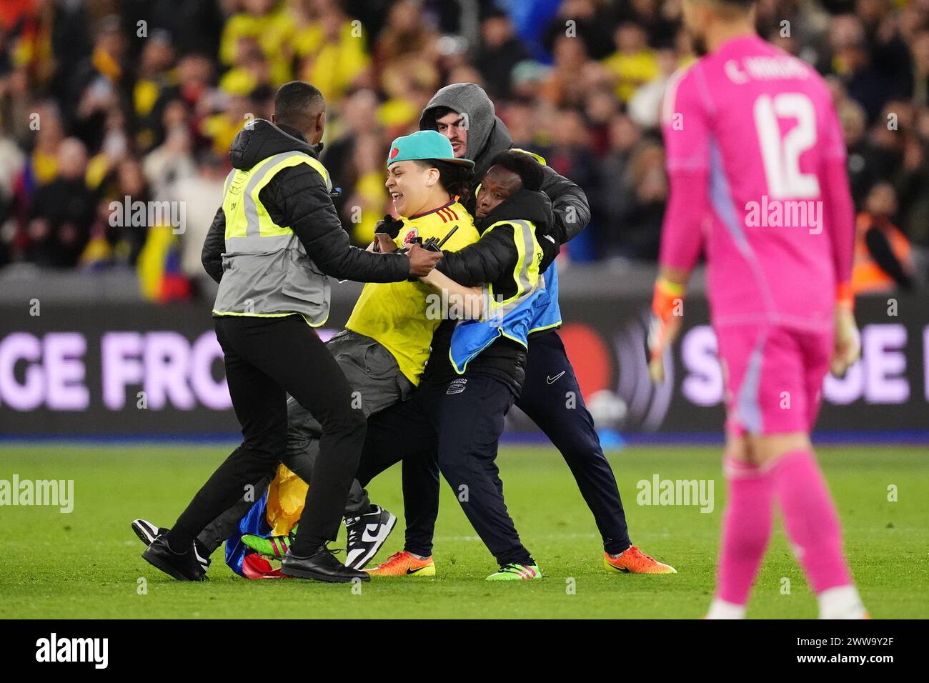 A pitch invader is tackled by stewards following an international ...