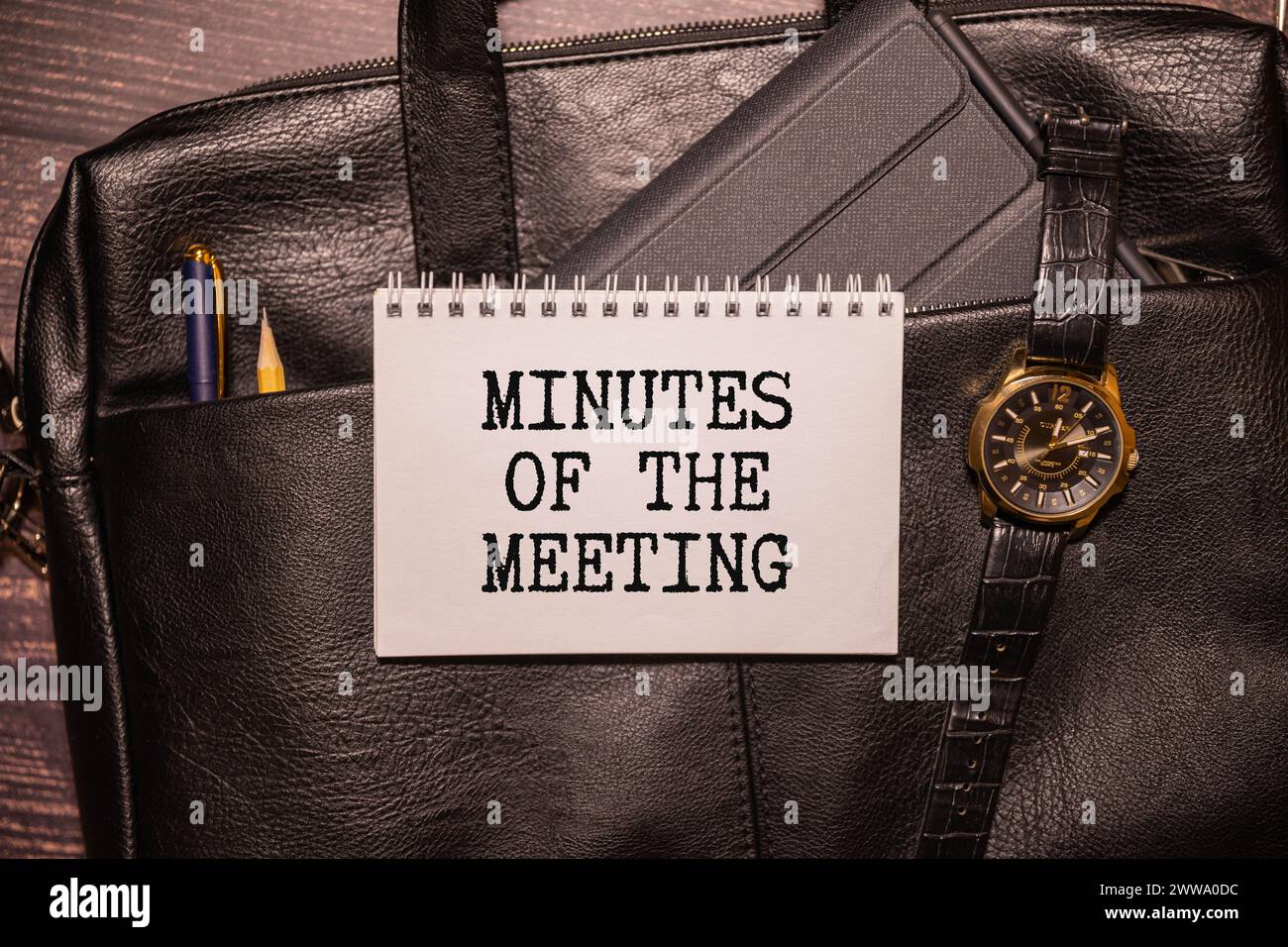 Paper plate with text MINUTES OF THE MEETING. Diagram, notepad and blue ...