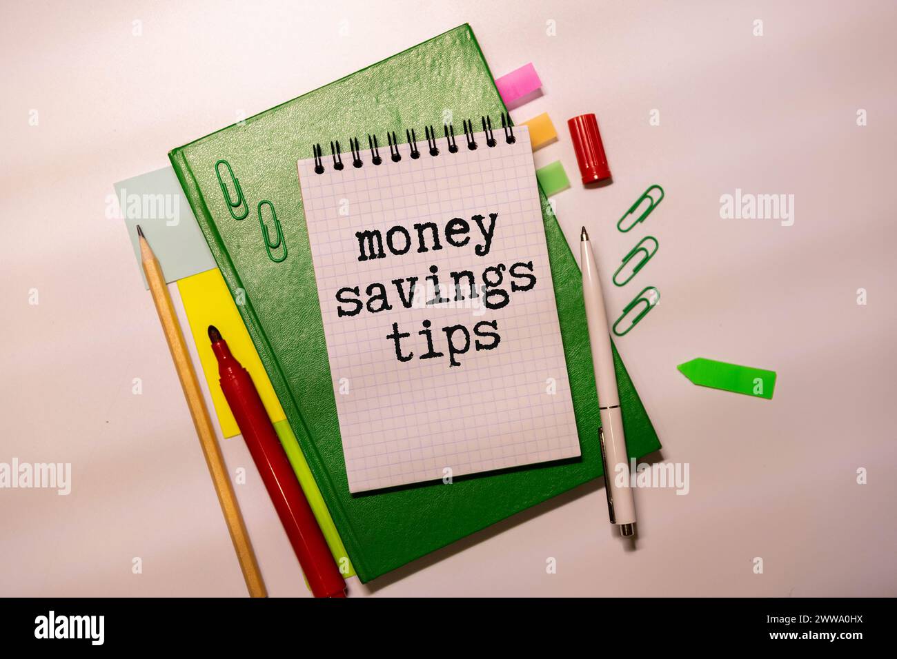 Money Savings Tips, text on small notepad with pen and calculator Stock ...