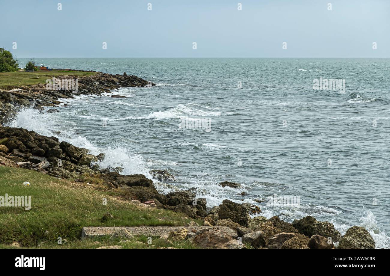 Cartagena, Colombia - July 25, 2023: Green with black rocks shoreline ...