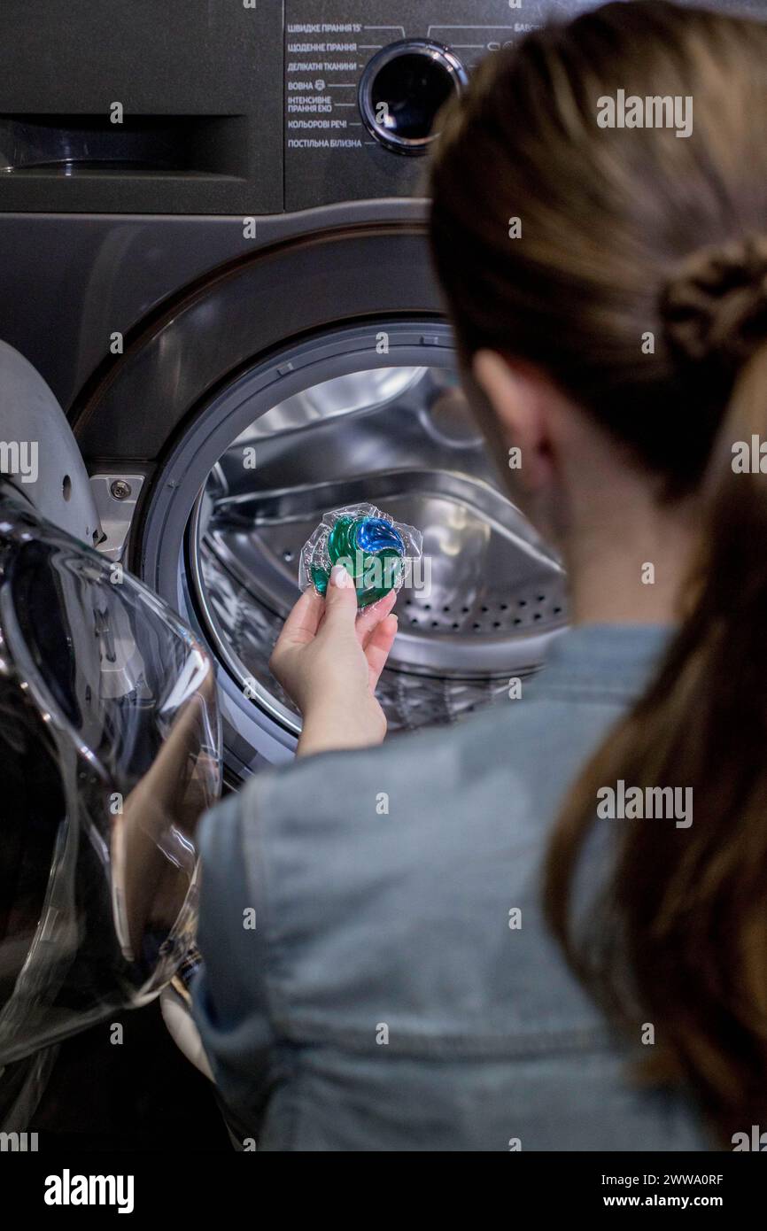 Woman putting detergent tablet hi-res stock photography and images - Alamy