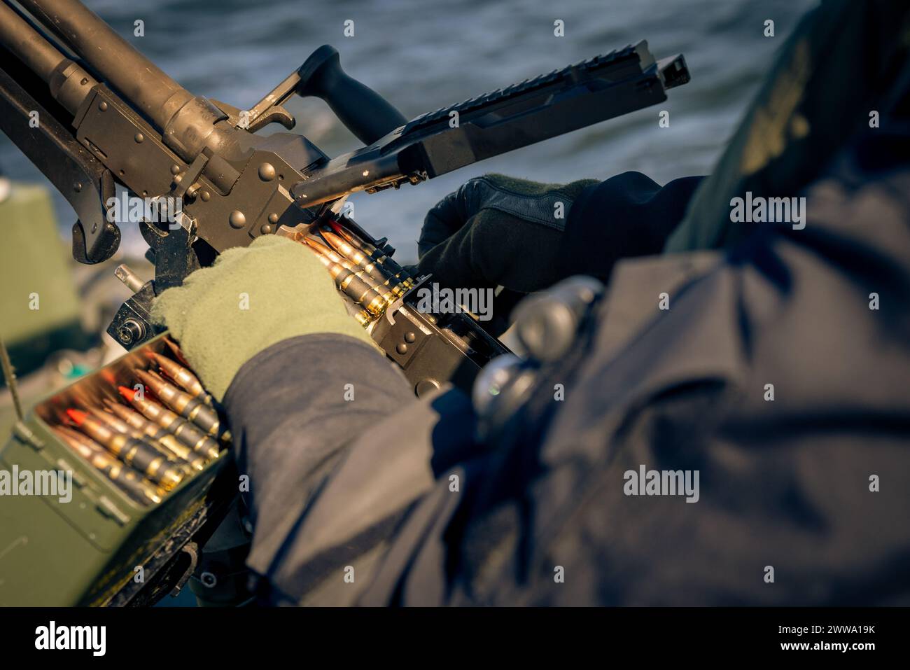A Korps Marinier with the Royal Netherlands Marine Corps loads an M240B ...