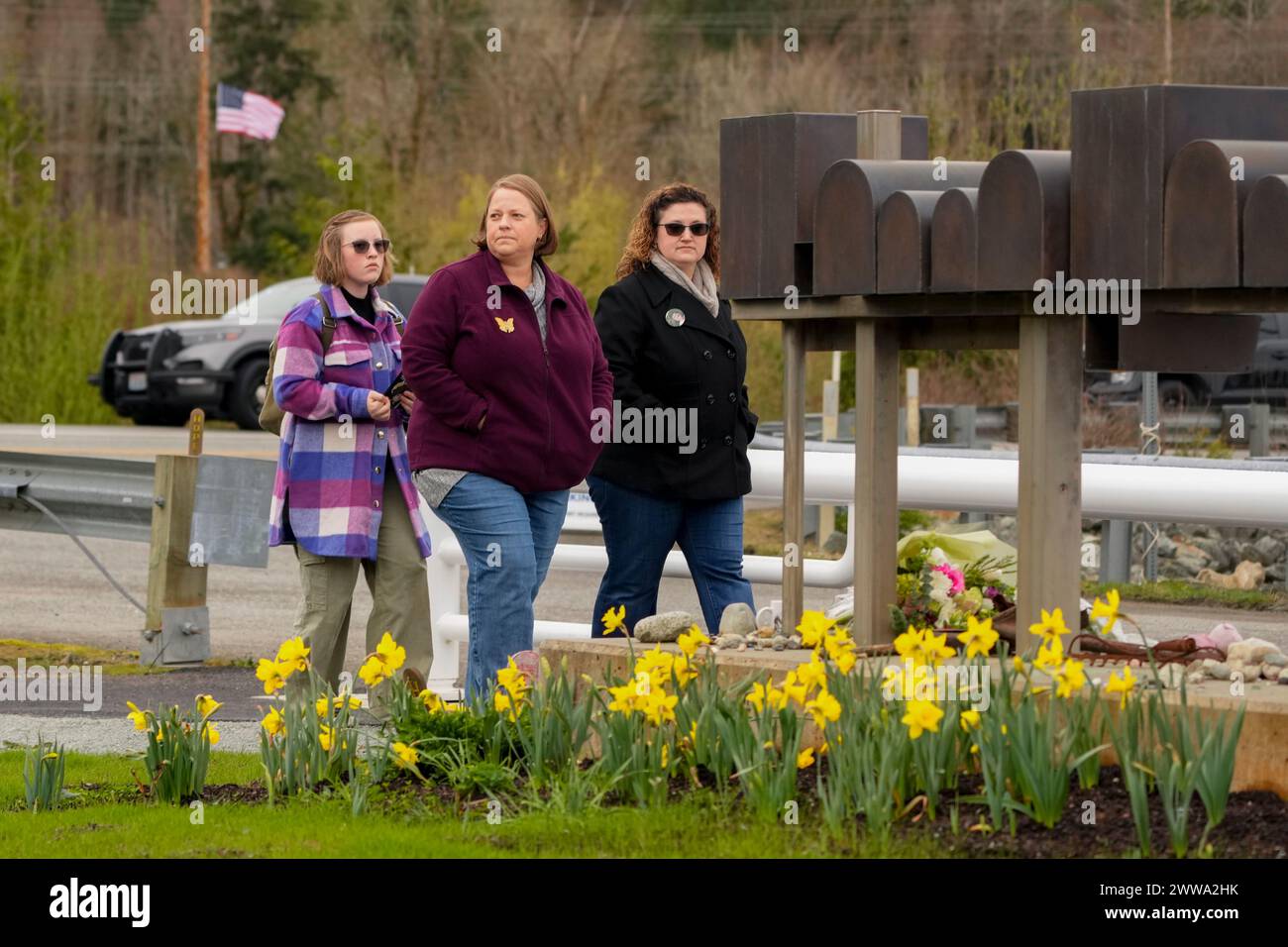 People walk by a mailbox art installation while arriving for the Oso ...