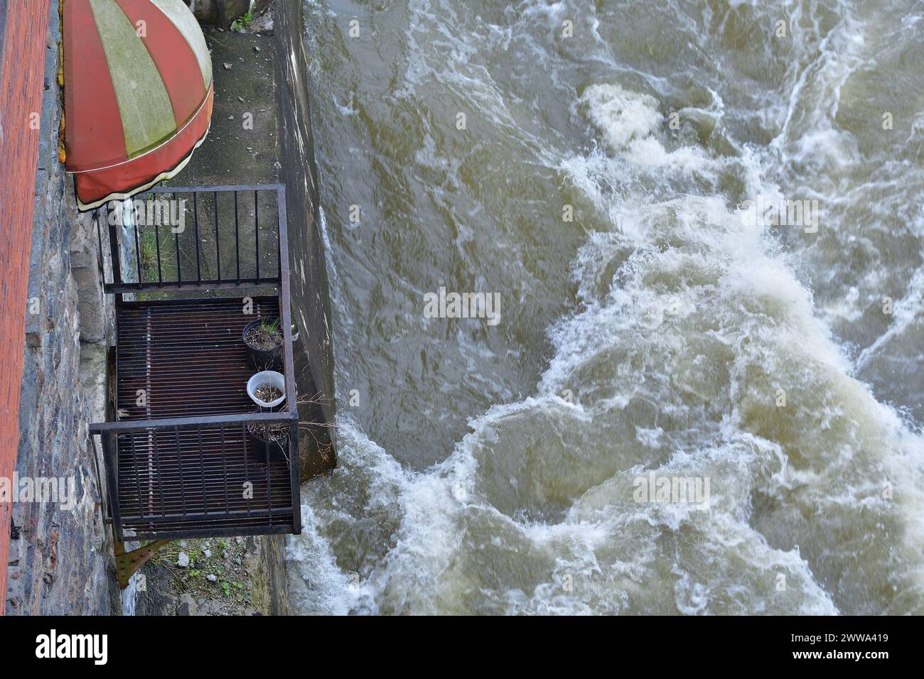 Exterior door above rushing water in Magog river. Dangerous situation ...