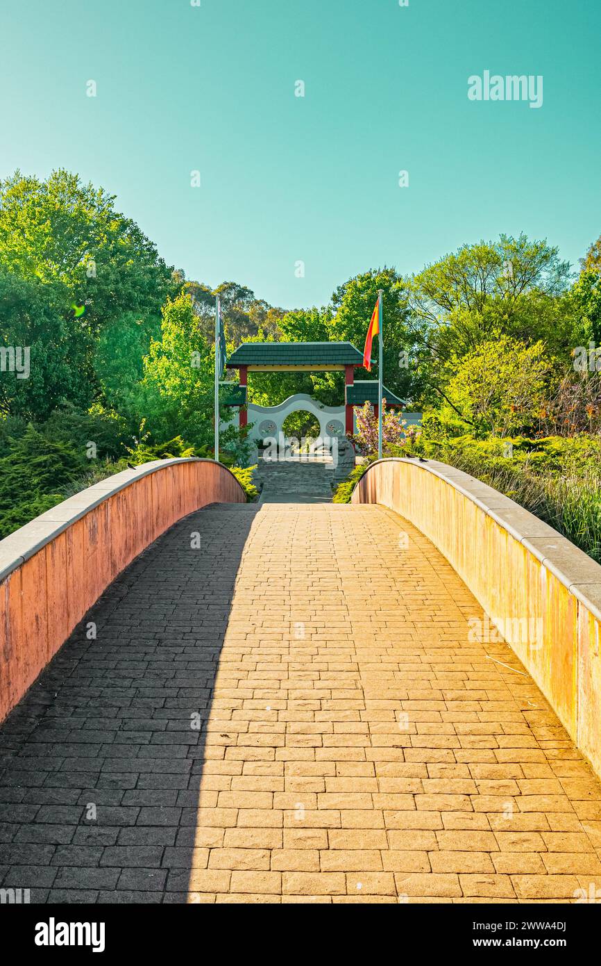 Paved bridge leading to a peaceful garden with traditional Asian ...