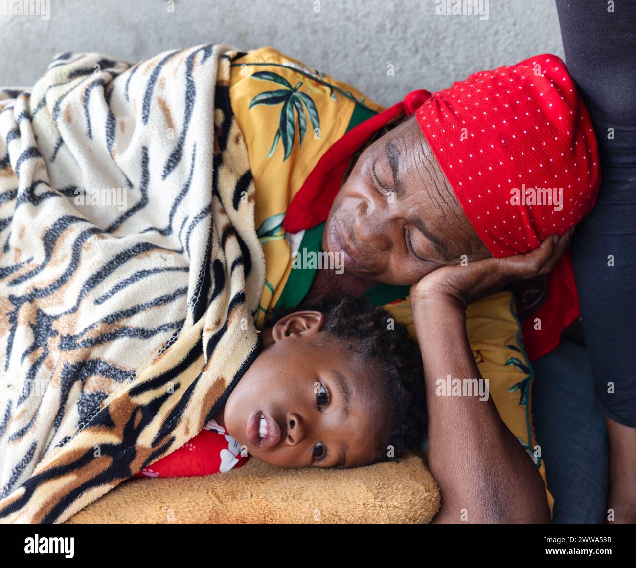 african village life, old woman and a girl fast asleep under a blanket ...