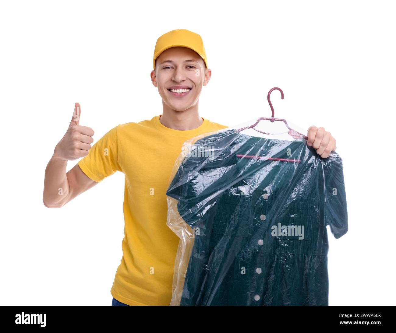 Dry-cleaning delivery. Happy courier holding dress in plastic bag and ...
