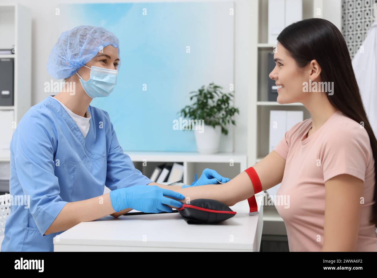 Laboratory testing. Doctor taking blood sample from patient at white ...