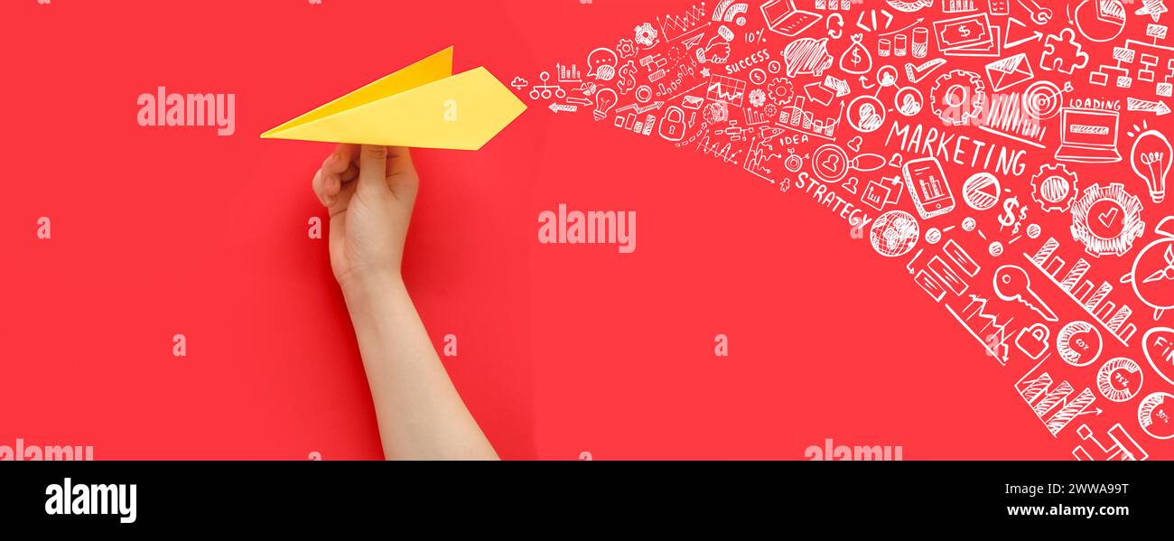 Hand with paper plane and drawn icons on red background. Concept of ...