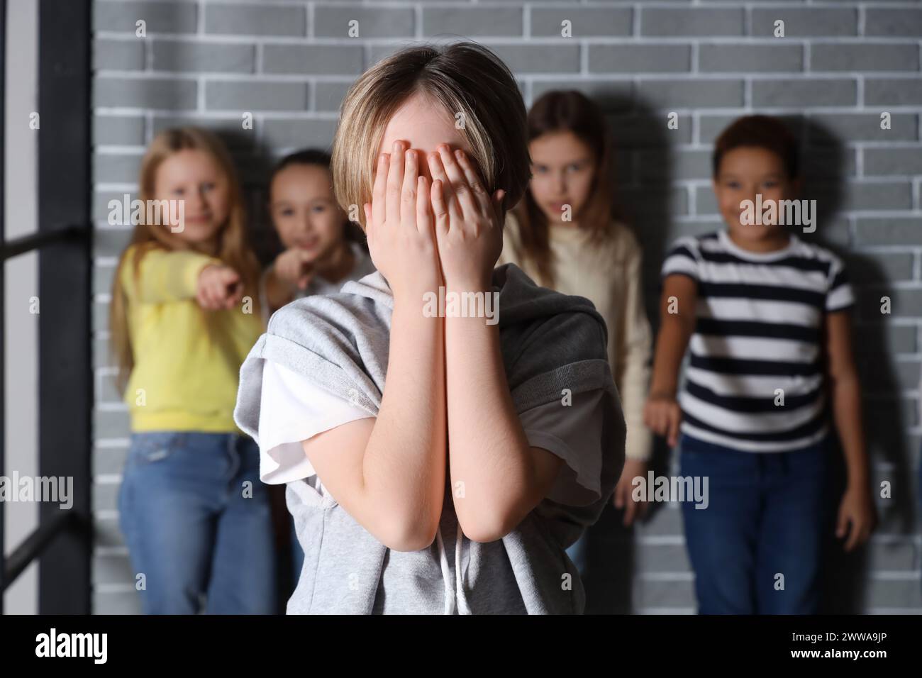 Bullied little boy crying at school Stock Photo - Alamy