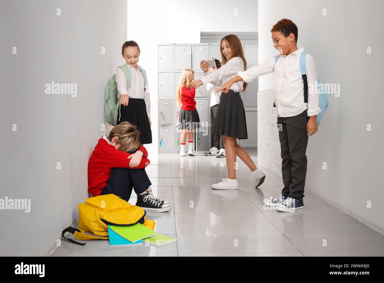 Little children bullying their classmate at school hall Stock Photo - Alamy