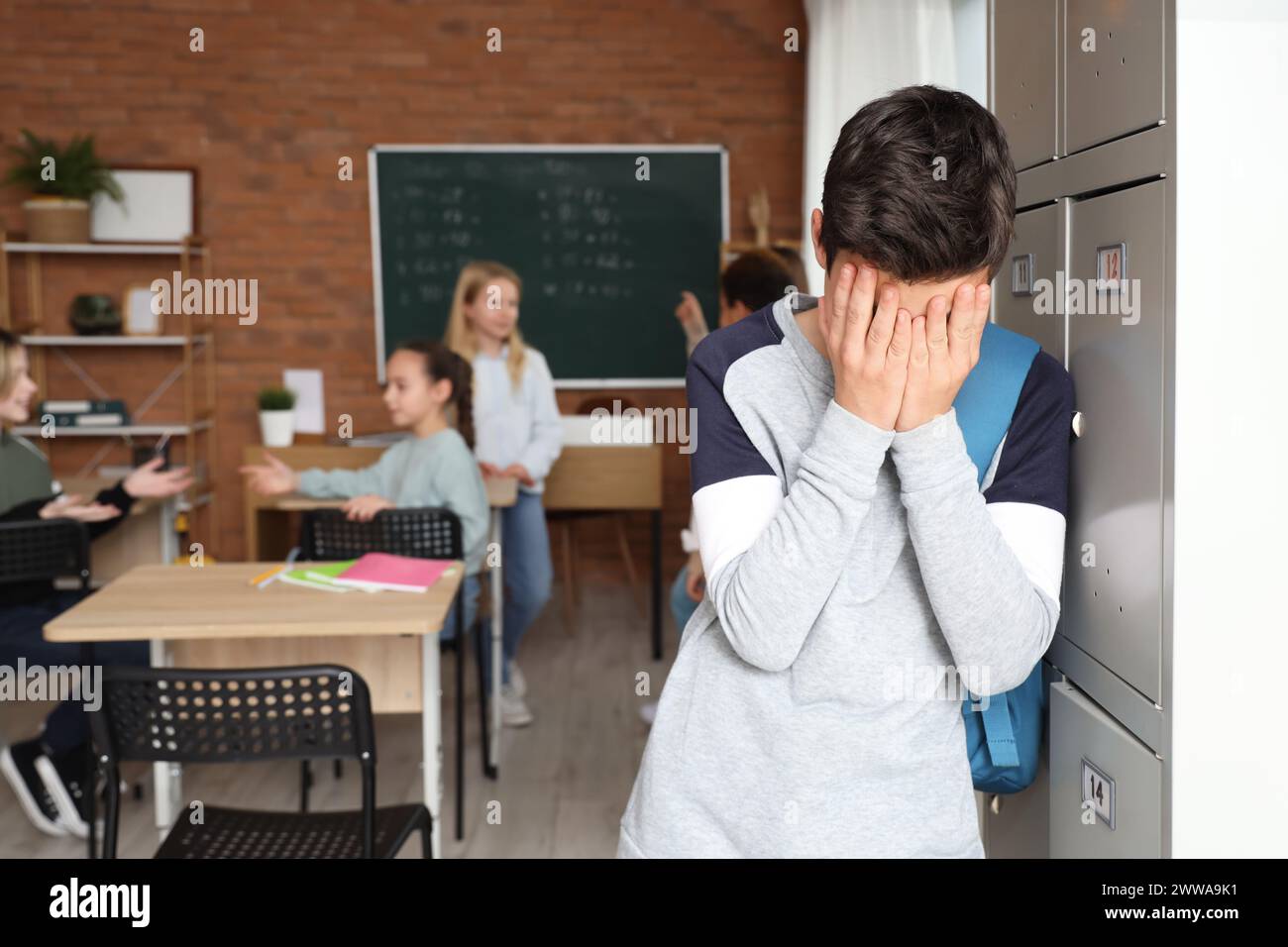 Bullied little boy crying near locker in classroom Stock Photo - Alamy Bullied little boy crying near locker in classroom Stock Photo - Alamy