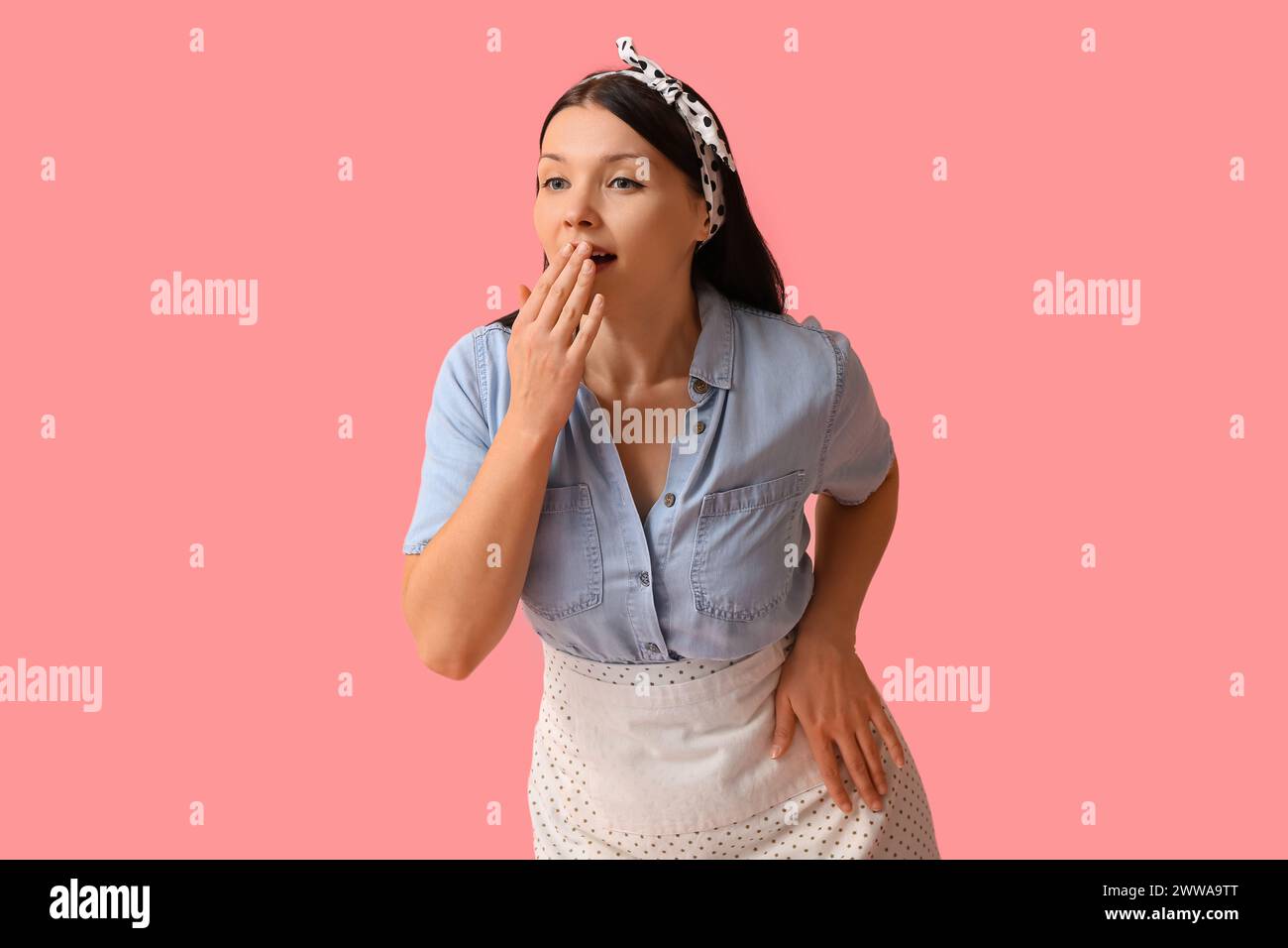 Shocked young waitress on pink background Stock Photo - Alamy