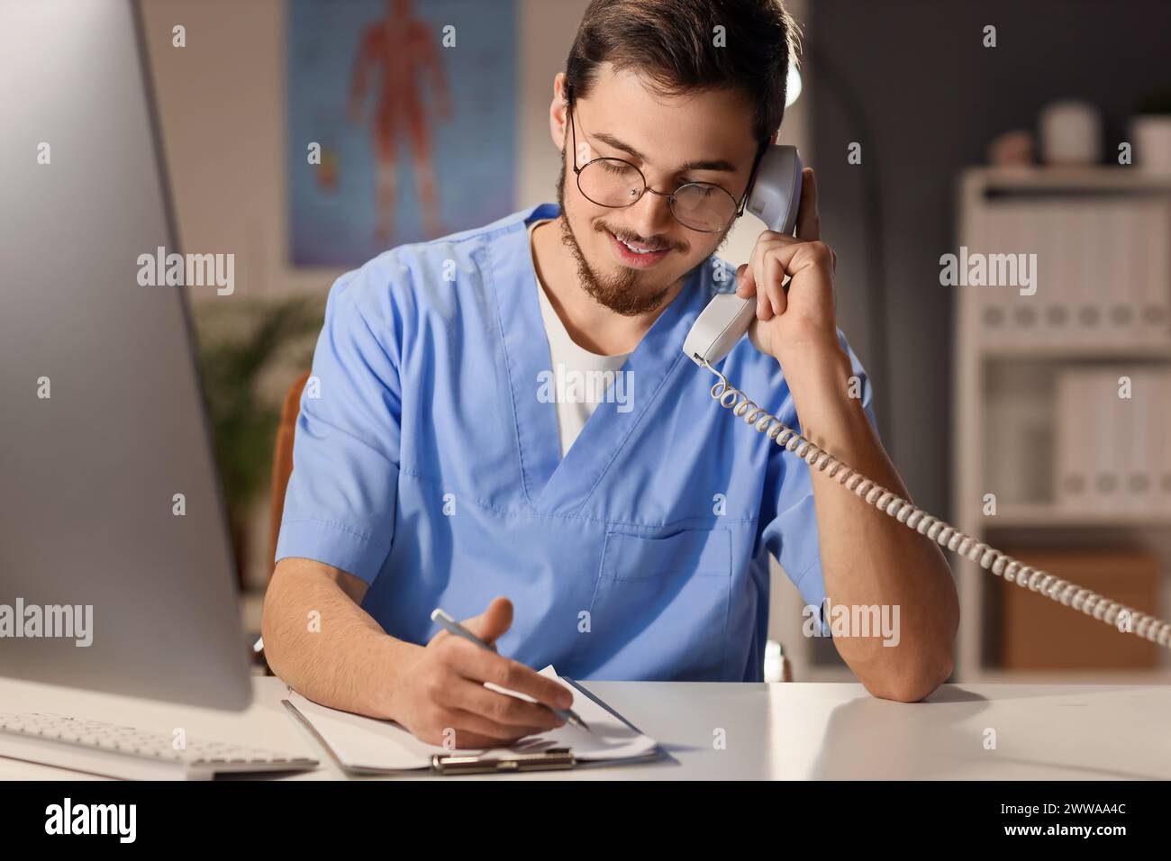 Male nurse talking by telephone at hospital in evening Stock Photo - Alamy