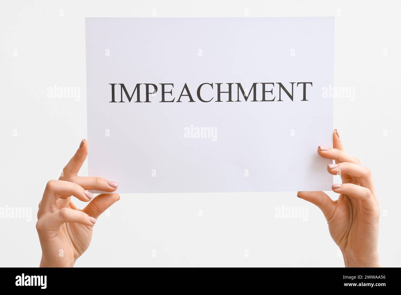 Woman holding IMPEACHMENT picket poster on white background Stock Photo ...