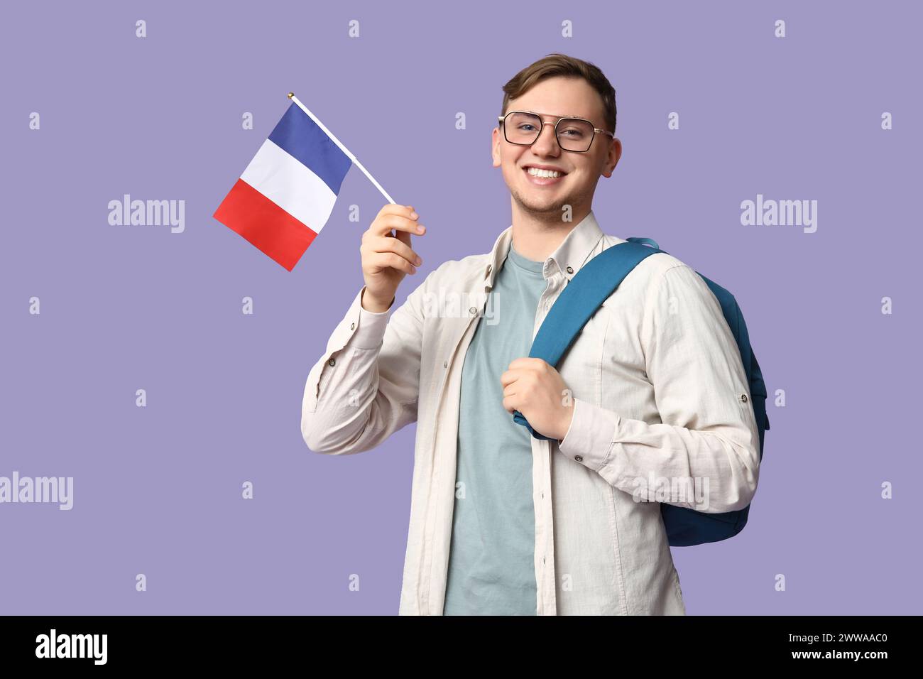 Male student with French flag on lilac background Stock Photo - Alamy