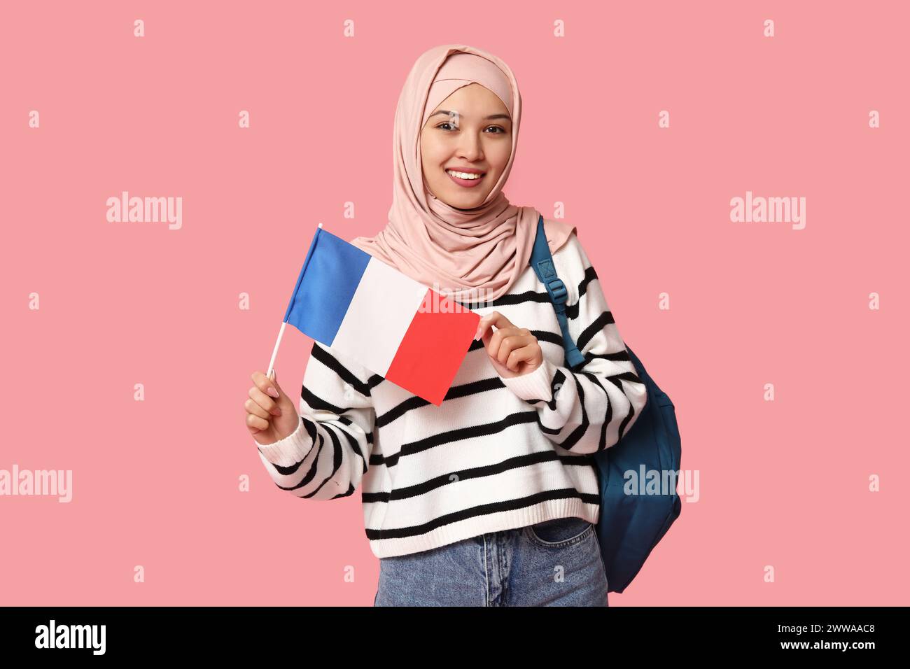 Female Muslim student with French flag on pink background Stock Photo ...