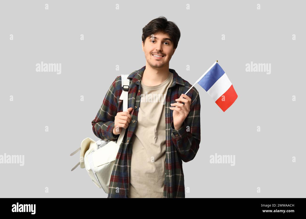 Male student with French flag on grey background Stock Photo - Alamy