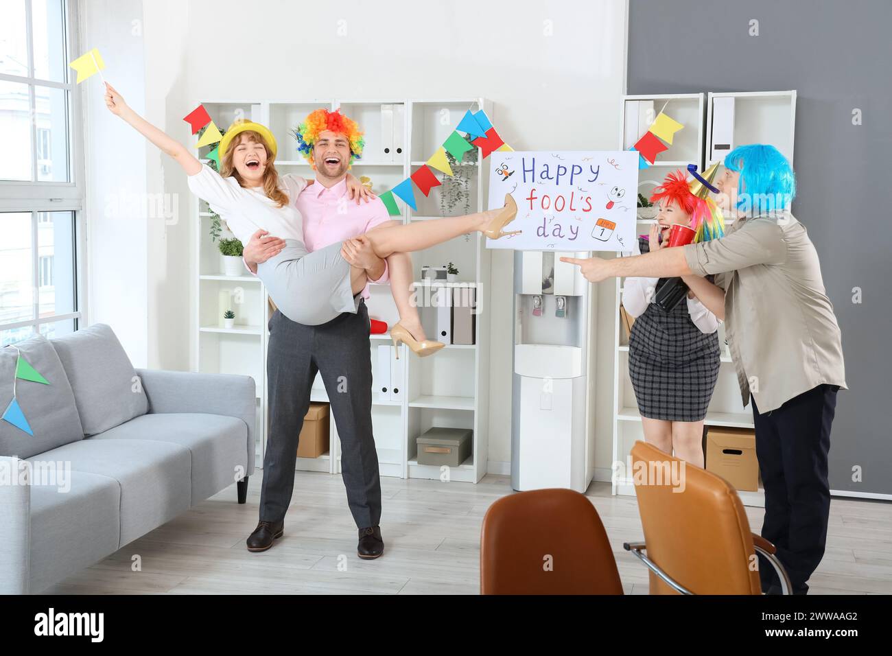 Business people celebrating April Fools' Day at office party Stock ...