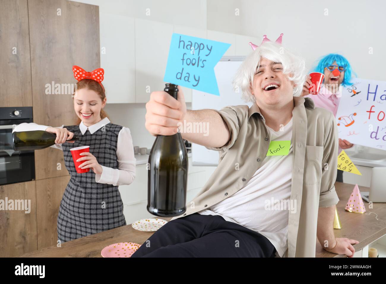 Business man with his colleagues celebrating April Fools' Day at office ...
