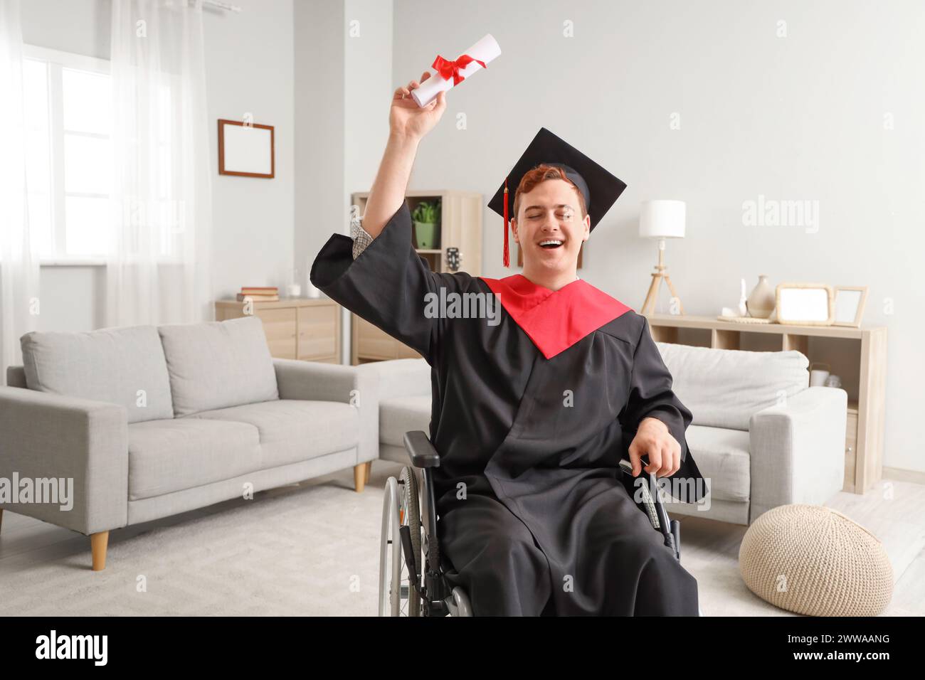 Happy male graduate in wheelchair with diploma at home Stock Photo - Alamy