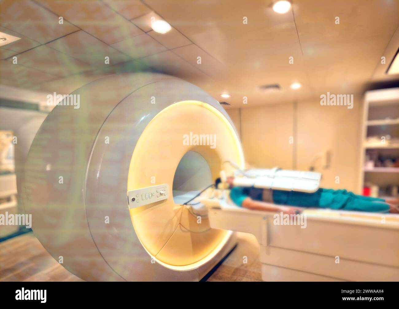 A patient lies down comfortably on the MRI scanner, undergoing a ...