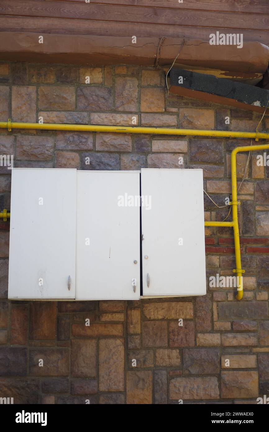 Two electrical boxes with lightning bolt on brick wall Stock Photo - Alamy