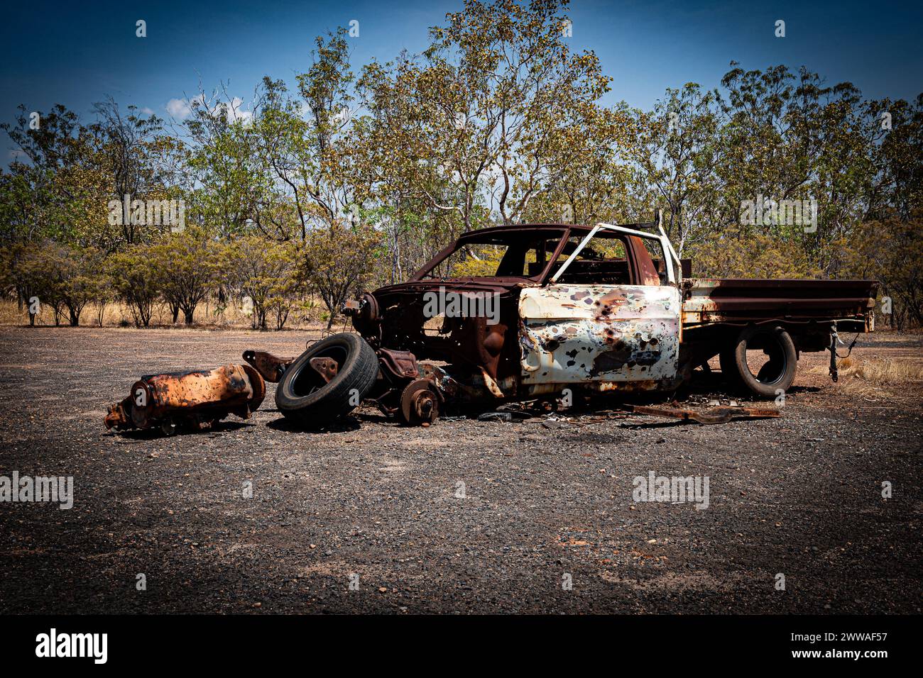 The remnants of a once-functional vehicle lay in ruins under the harsh ...