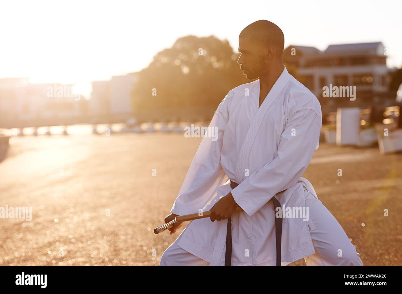 Serious man, karate and fitness with nunchuck in city for kata ...