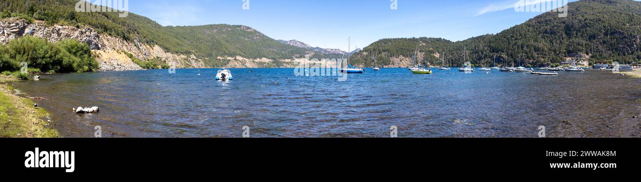 Panoramic photo of boats floating on enormous lake in a valley ...