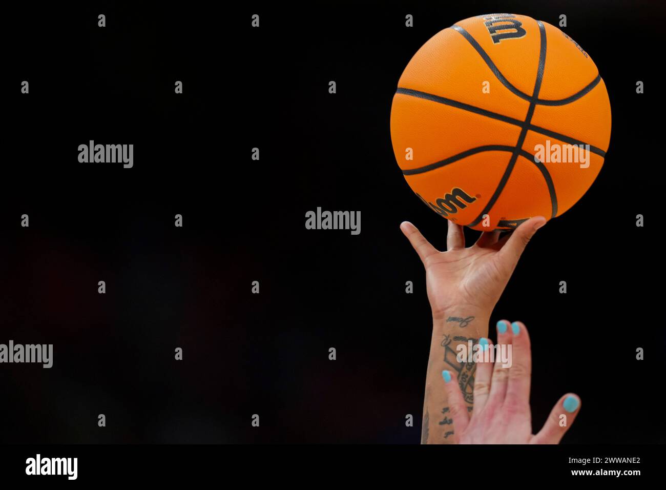 Player hands reach for the loose ball during a first-round college ...