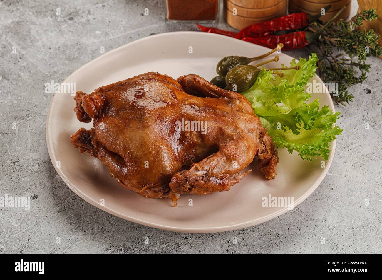 Baked whole small chicken with spices Stock Photo - Alamy