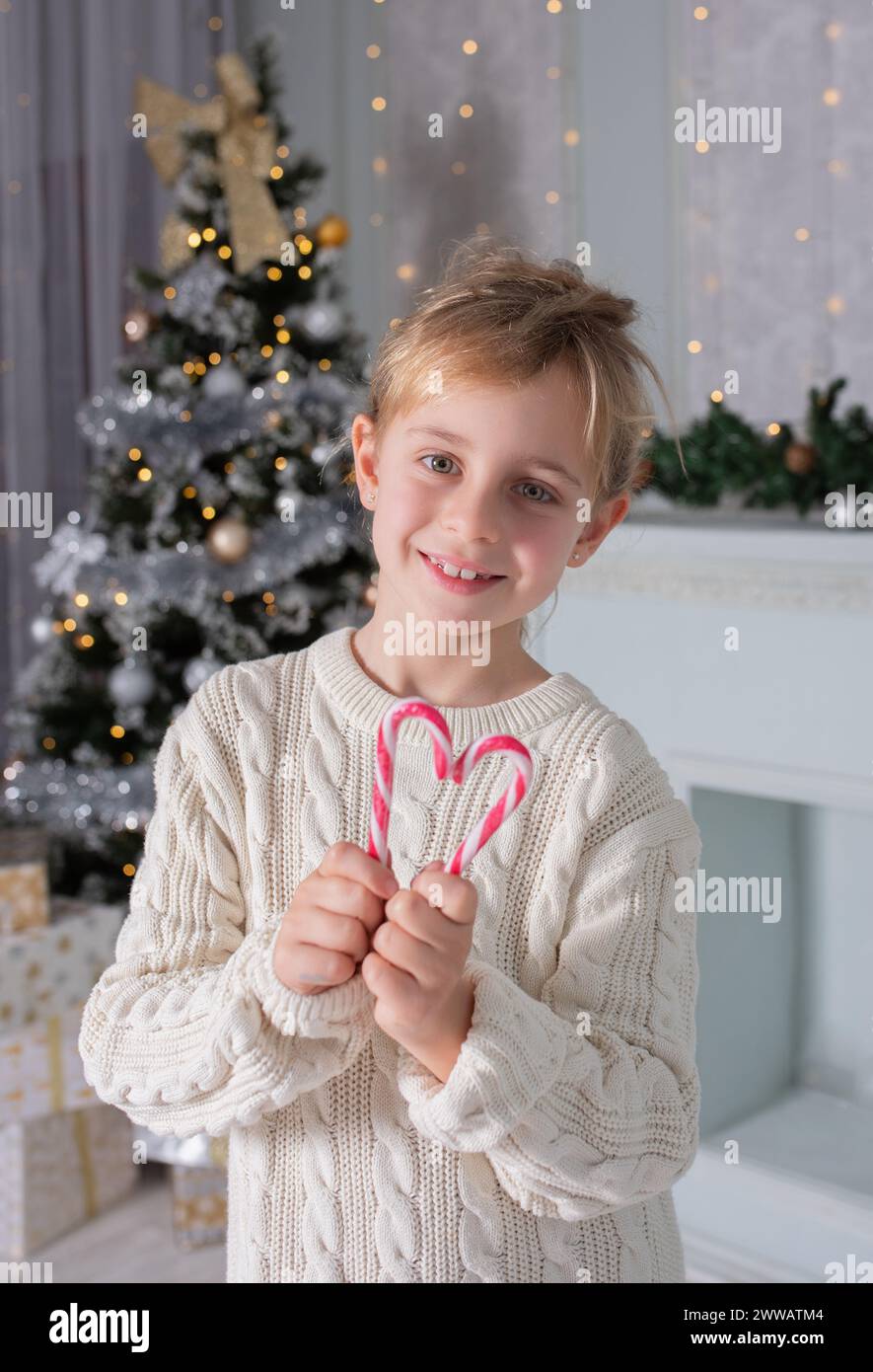 Christmas Candy Heart. New Year's little girl put together heart-shaped ...