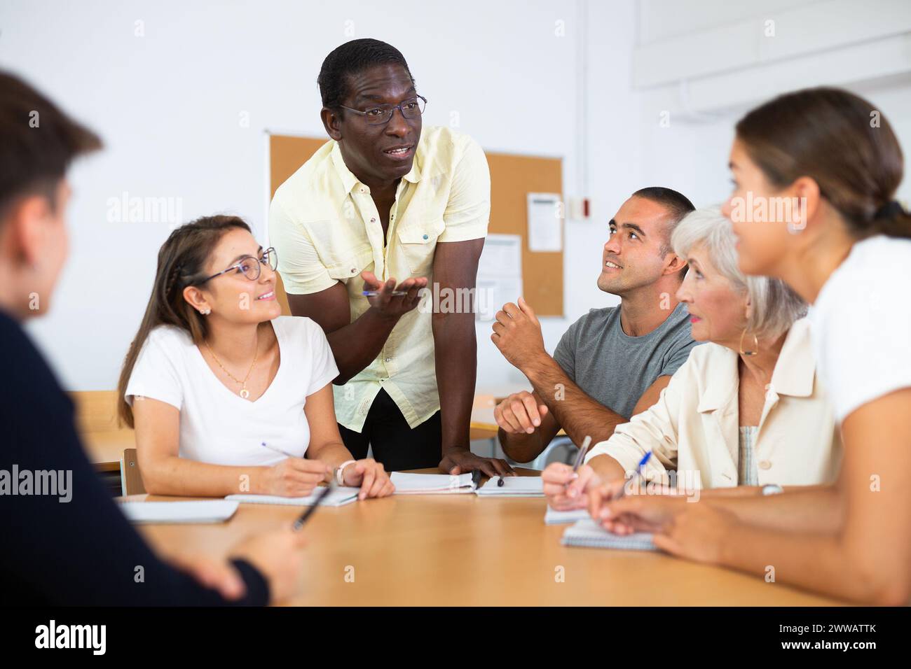 Diverse people on language courses in classroom Stock Photo - Alamy