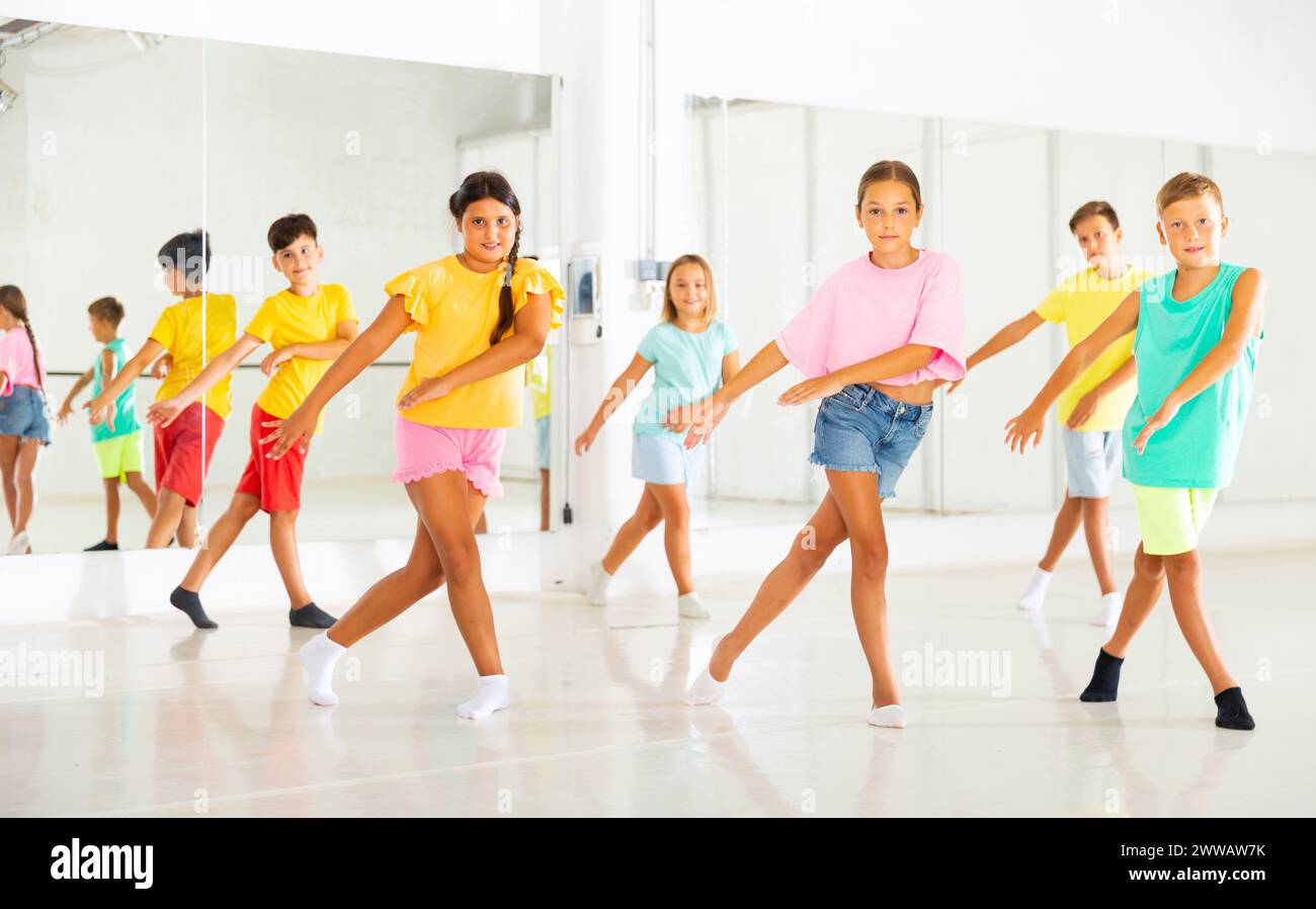 Happy tweens dancing during group class in choreographic studio Stock ...