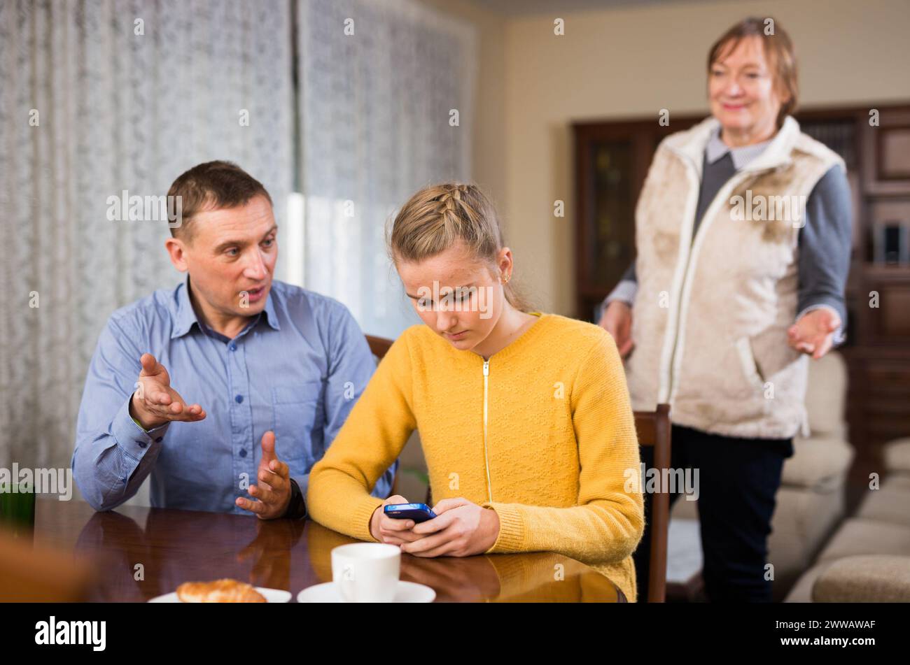 Woman and man lecturing teenage girl Stock Photo - Alamy