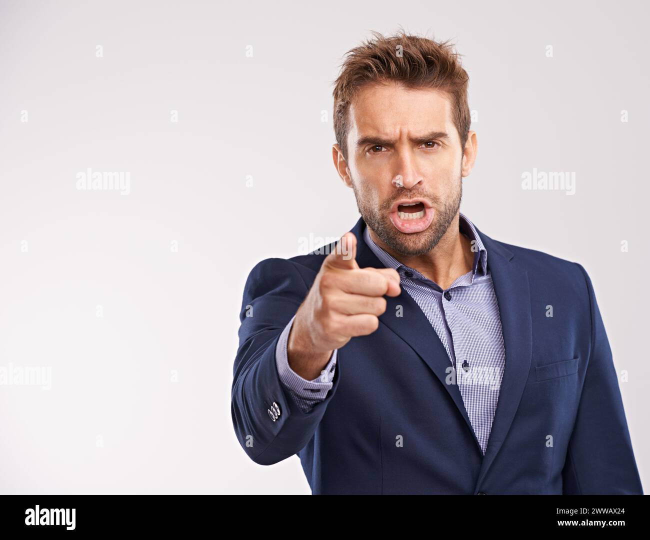 Entrepreneur, man and shout with pointing in studio white background to ...