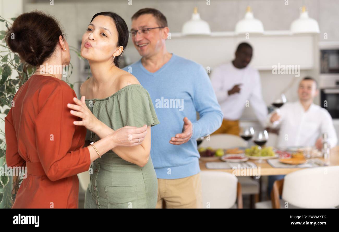 Women greeting each other with kiss hi-res stock photography and images ...