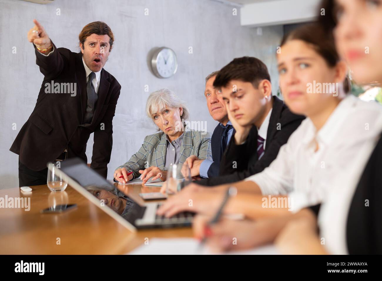 Angry boss scolding subordinates at meeting in office Stock Photo - Alamy