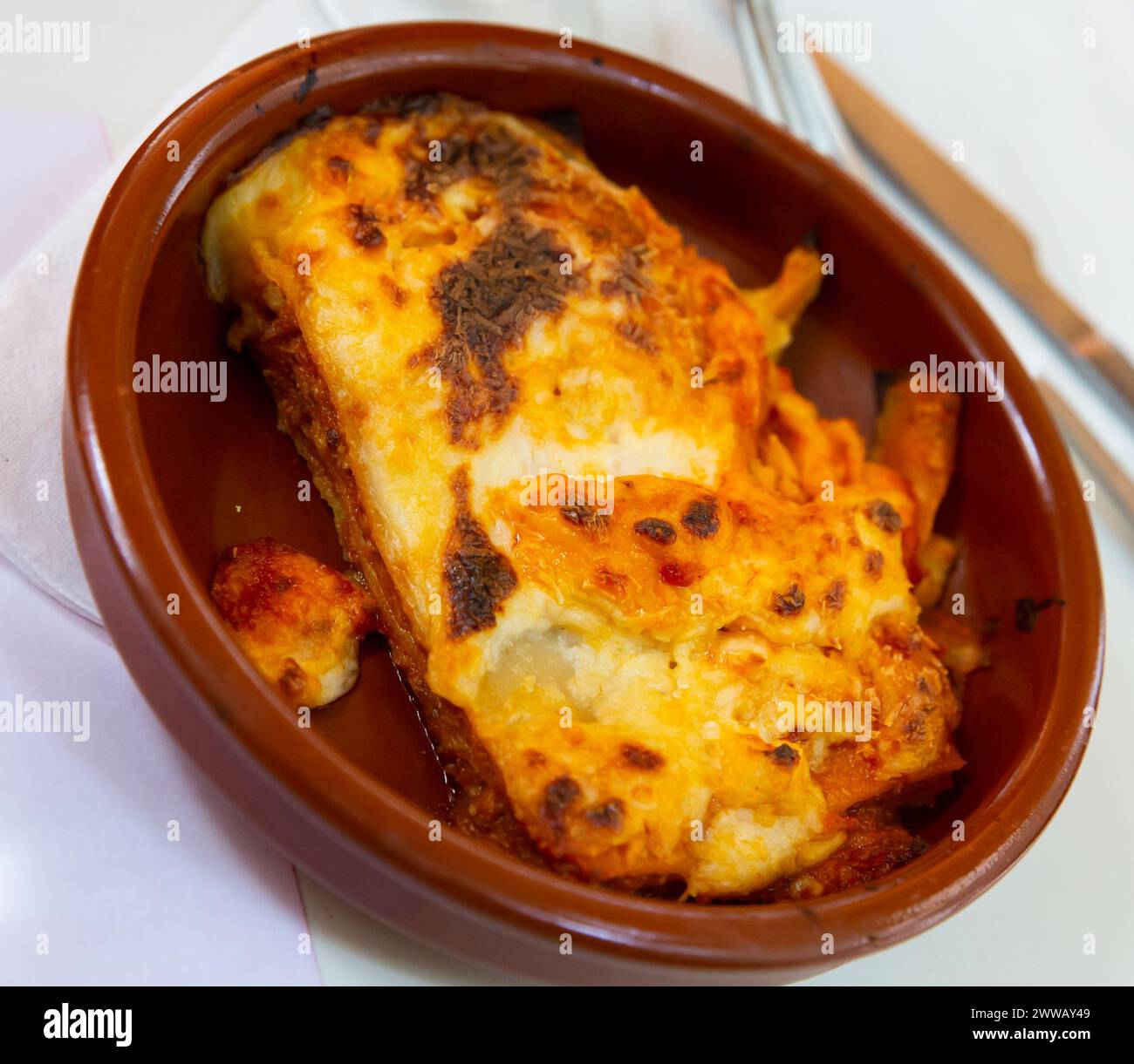 Italian meat lasagna in a clay plate Stock Photo - Alamy