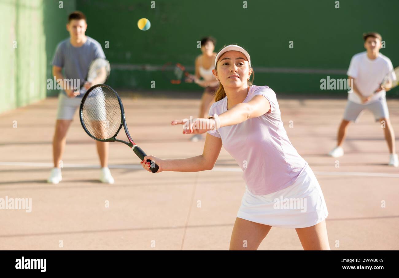 Woman serving ball during frontenis game outdoors Stock Photo - Alamy