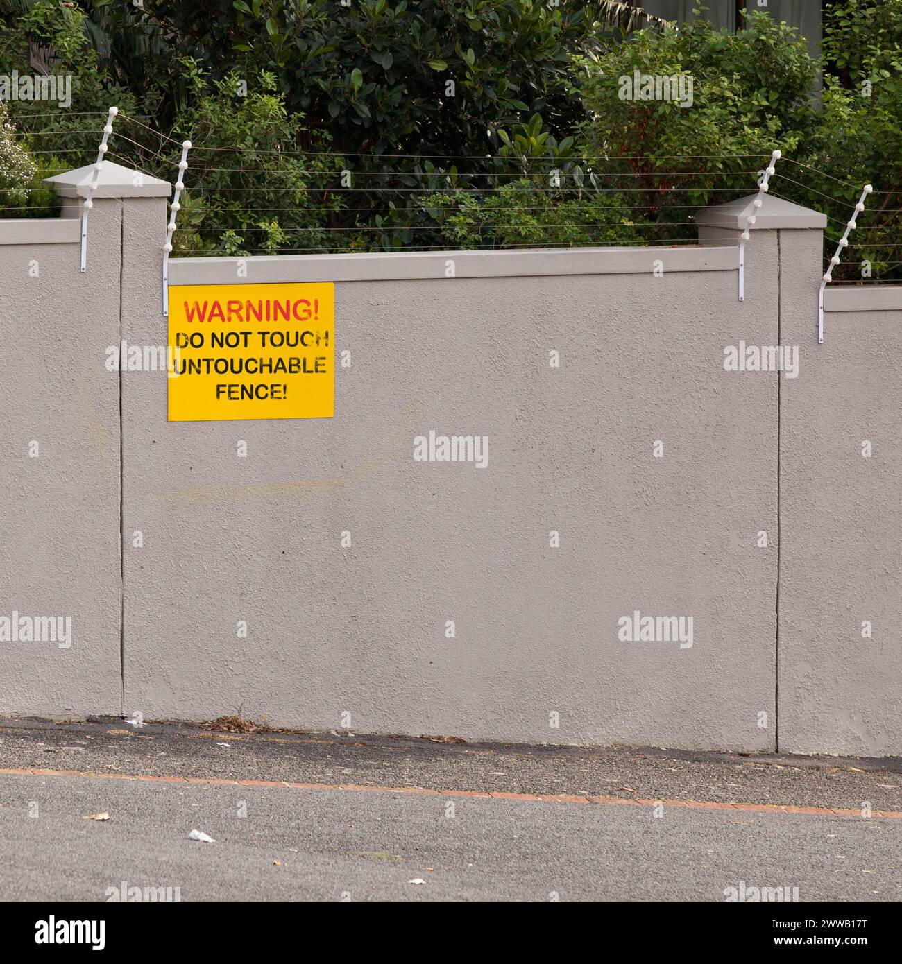 Electrical fence, warning and sign on wall of property for caution ...