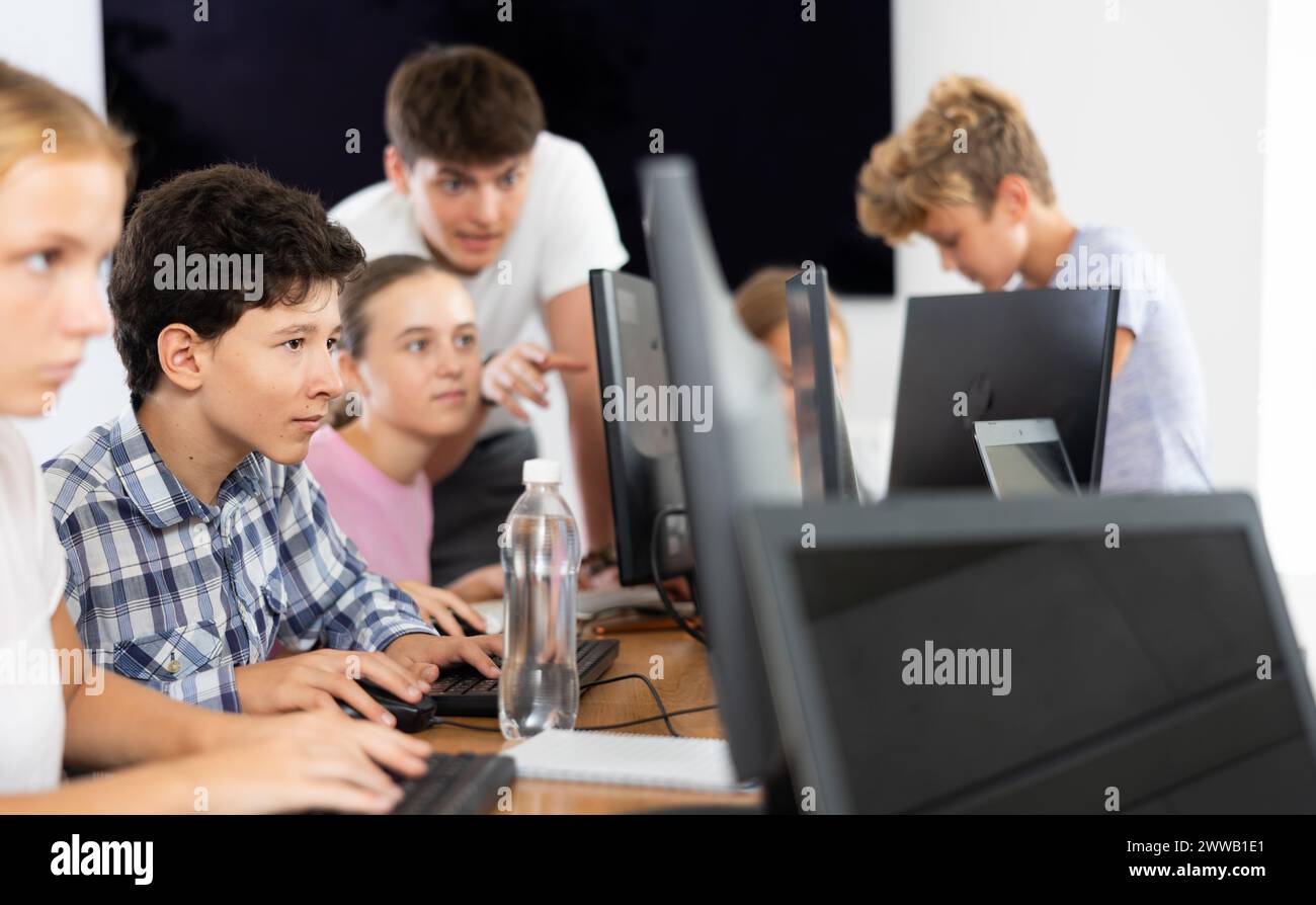 Boy student learning to work on computer in classroom Stock Photo - Alamy