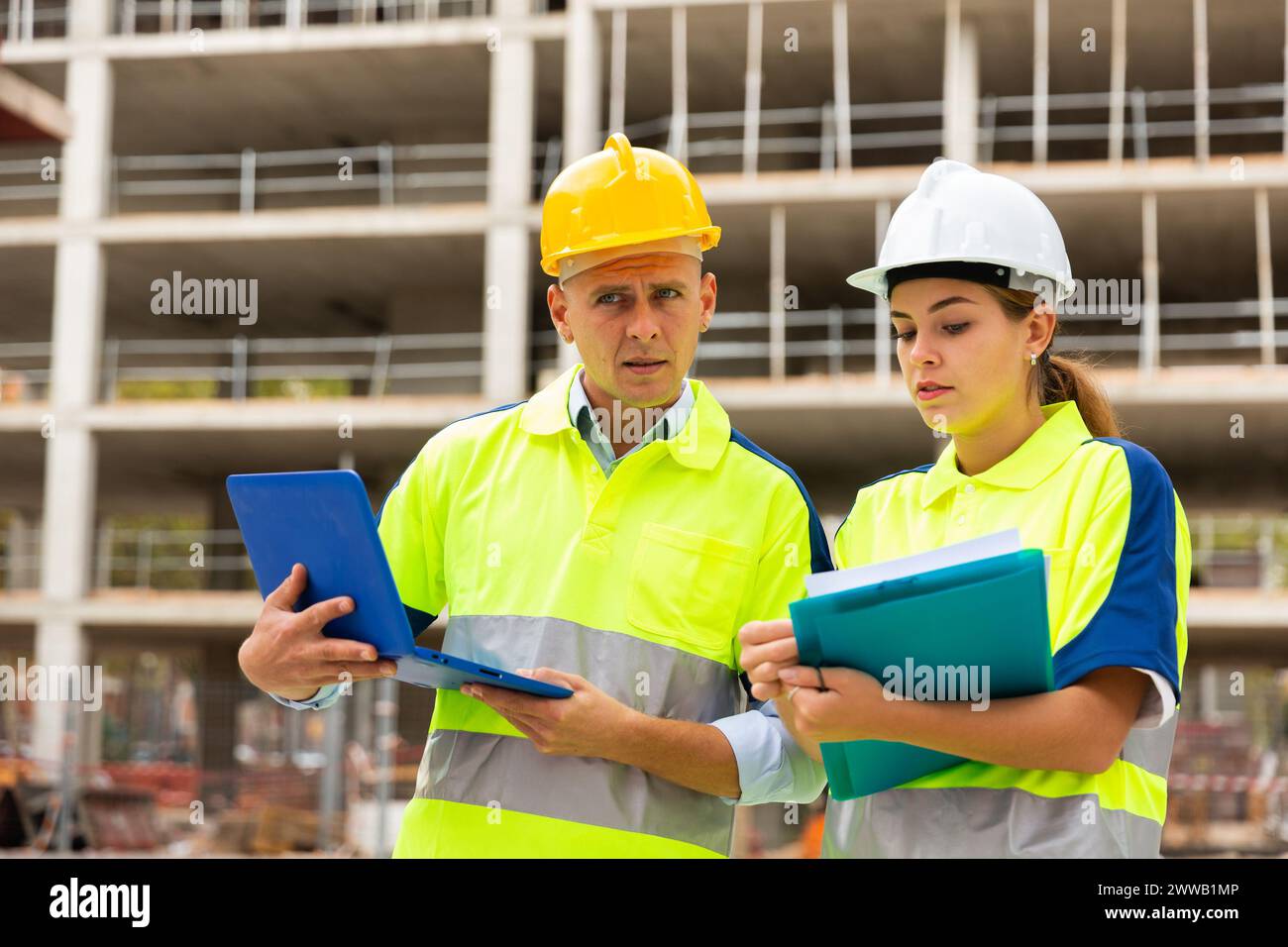 Man and woman engineers in construction site Stock Photo - Alamy