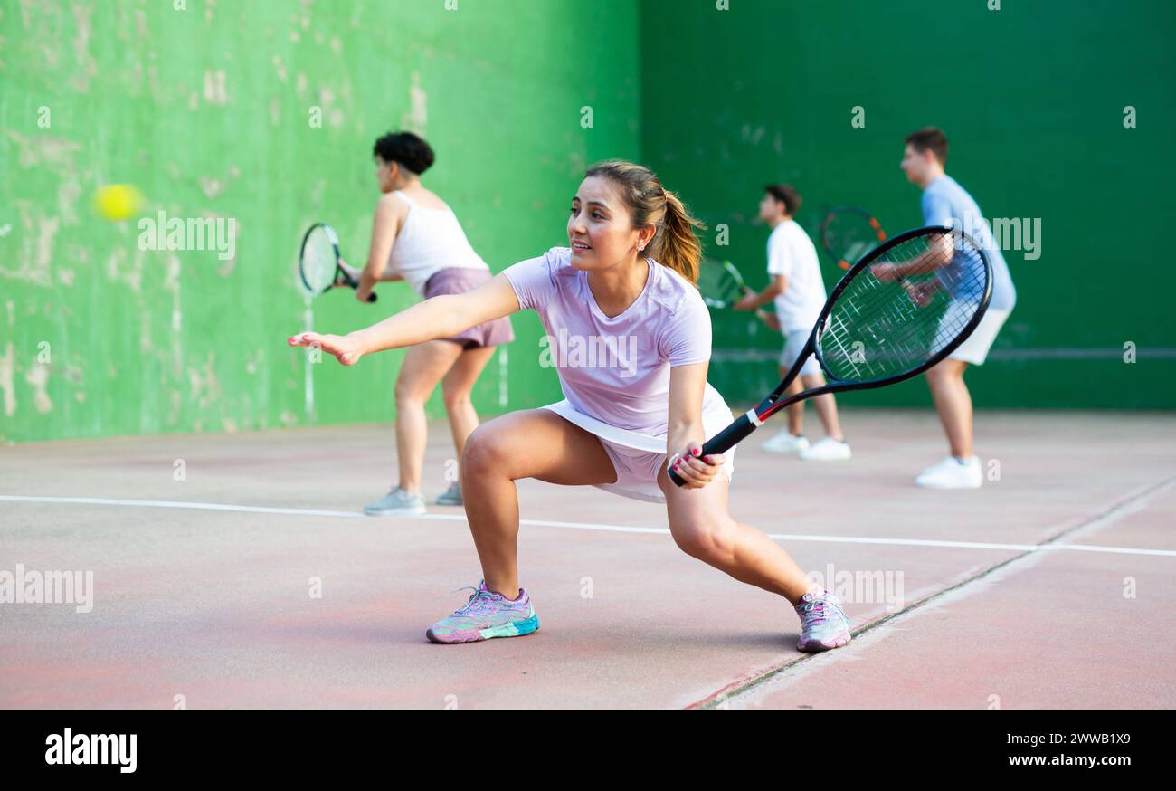 Woman serving ball during frontenis game outdoors Stock Photo - Alamy