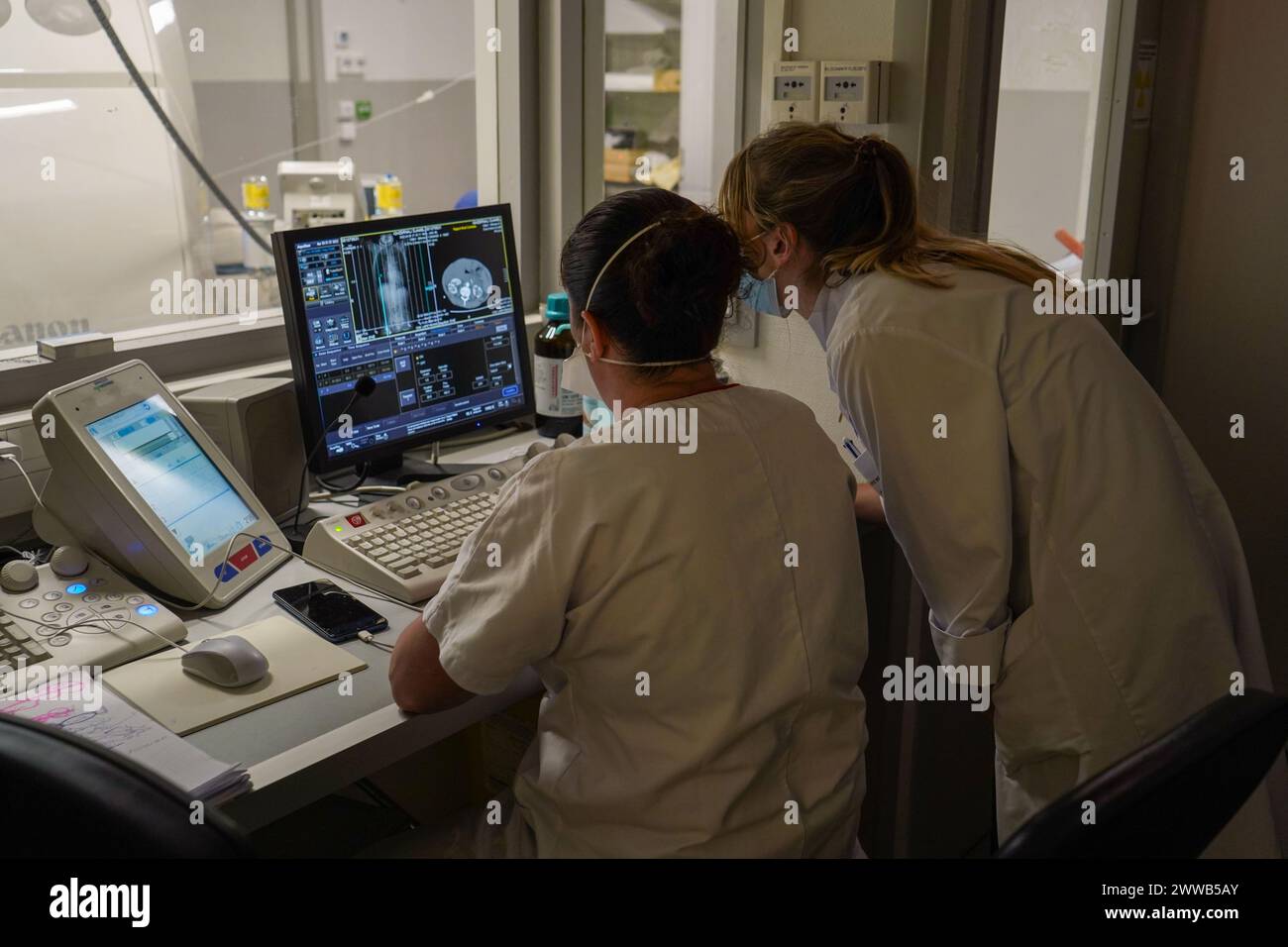 Doctors observing the images of a scanner in the emergency room of a ...